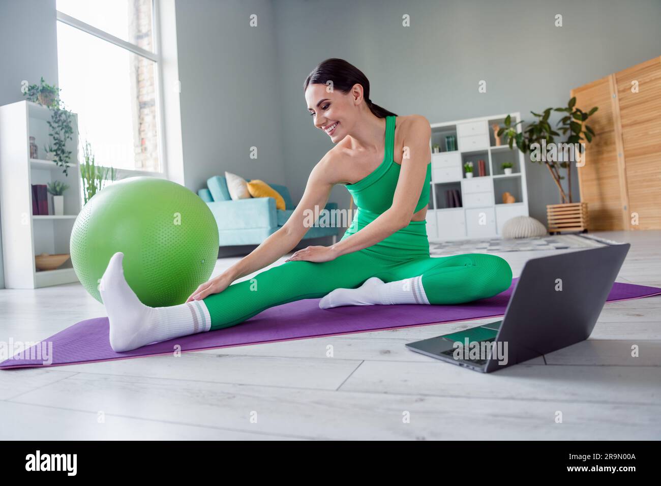 Photo of positive shiny lady wear sporty outfit holding online yoga ...