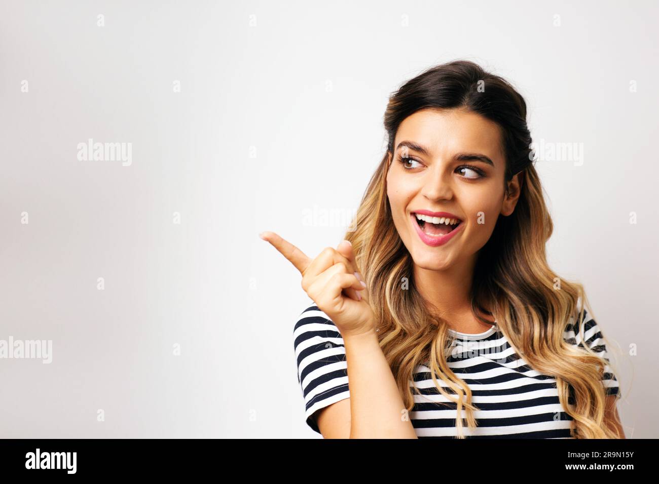 Woman pointing finger side hi-res stock photography and images - Alamy