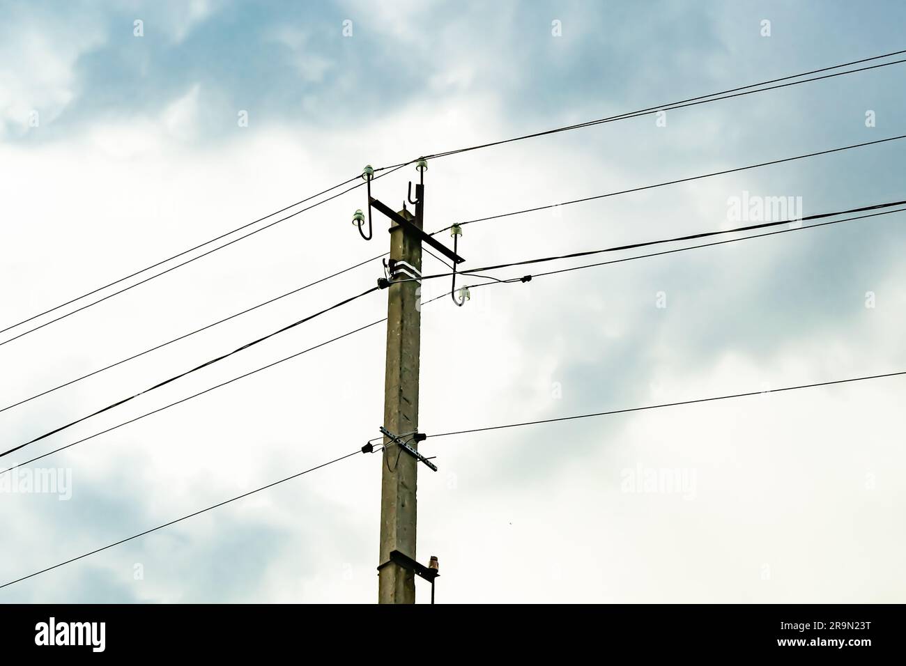 Power electric pole with line wire on colored background close up ...