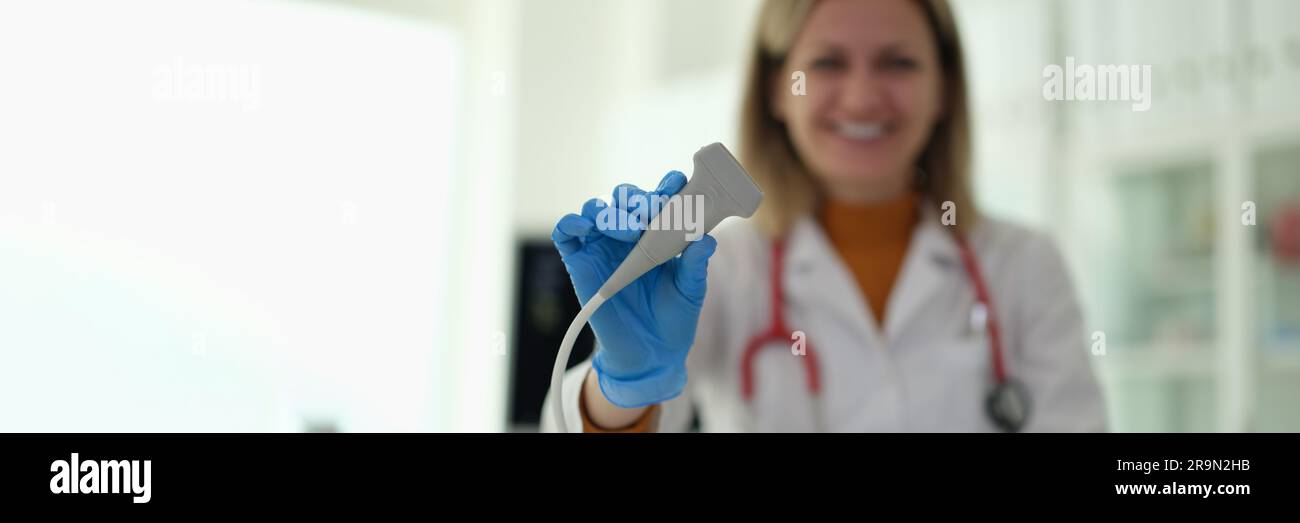 Doctor of ultrasound diagnostics holding probe in hands in clinic ...