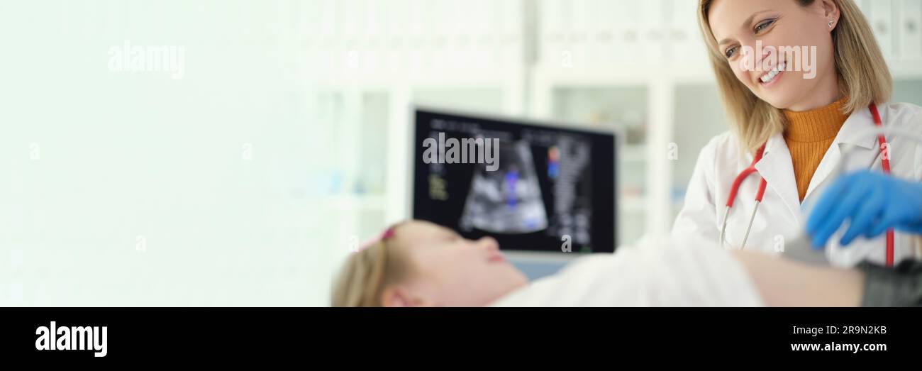 Doctor pediatrician conducting abdominal ultrasound examination of ...