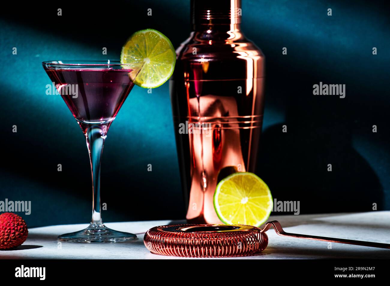 Alcoholic cocktail drink with vodka, dry gin, lychee, lime and ice in ...