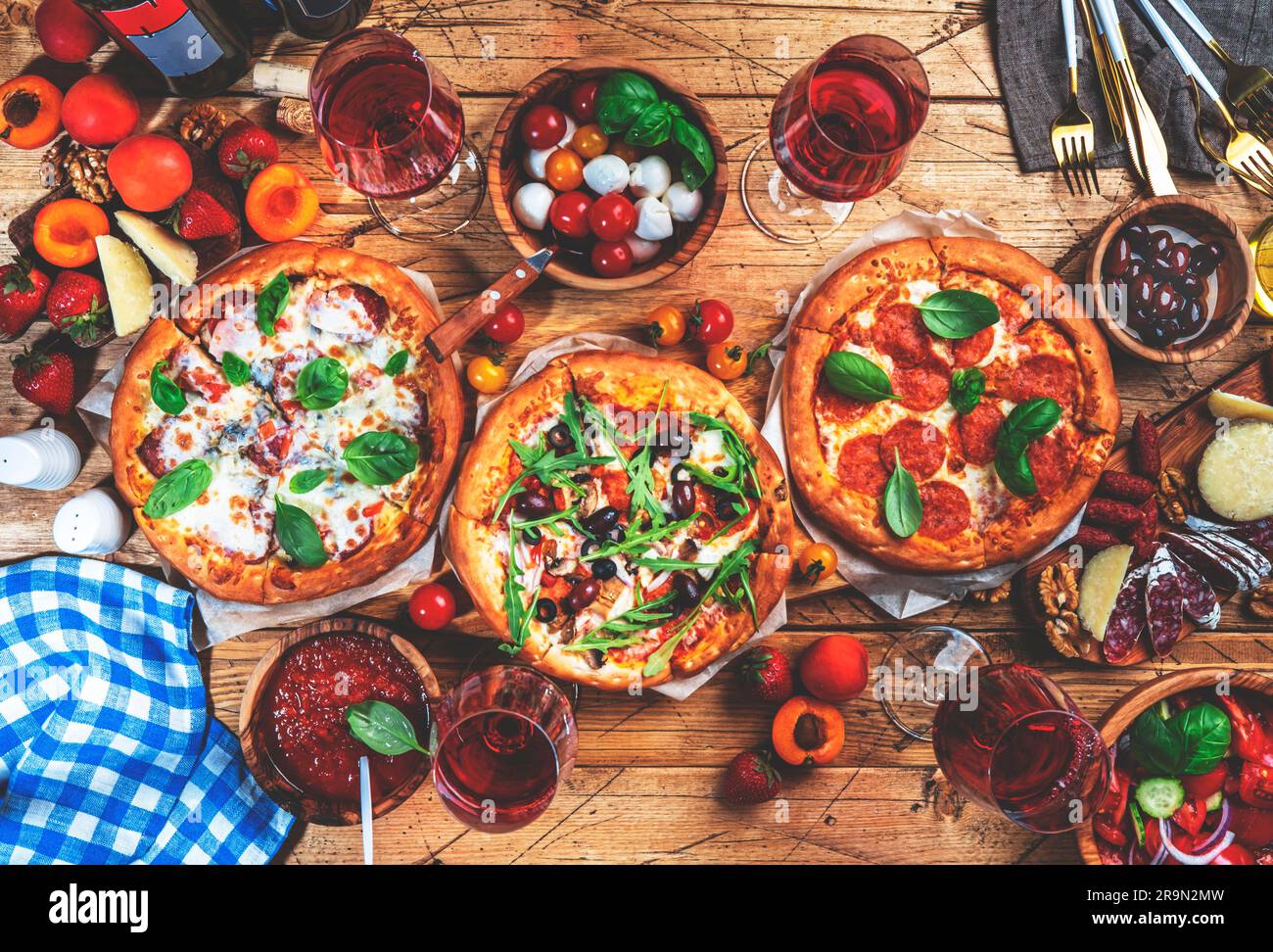 Pizza party table. Top view glasses with red wine, rustic wooden table ...