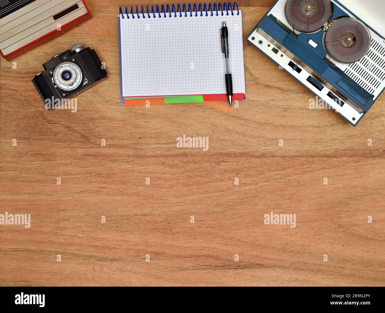 Old retro reel tape recorder, vintage radio, retro camera on wooden ...