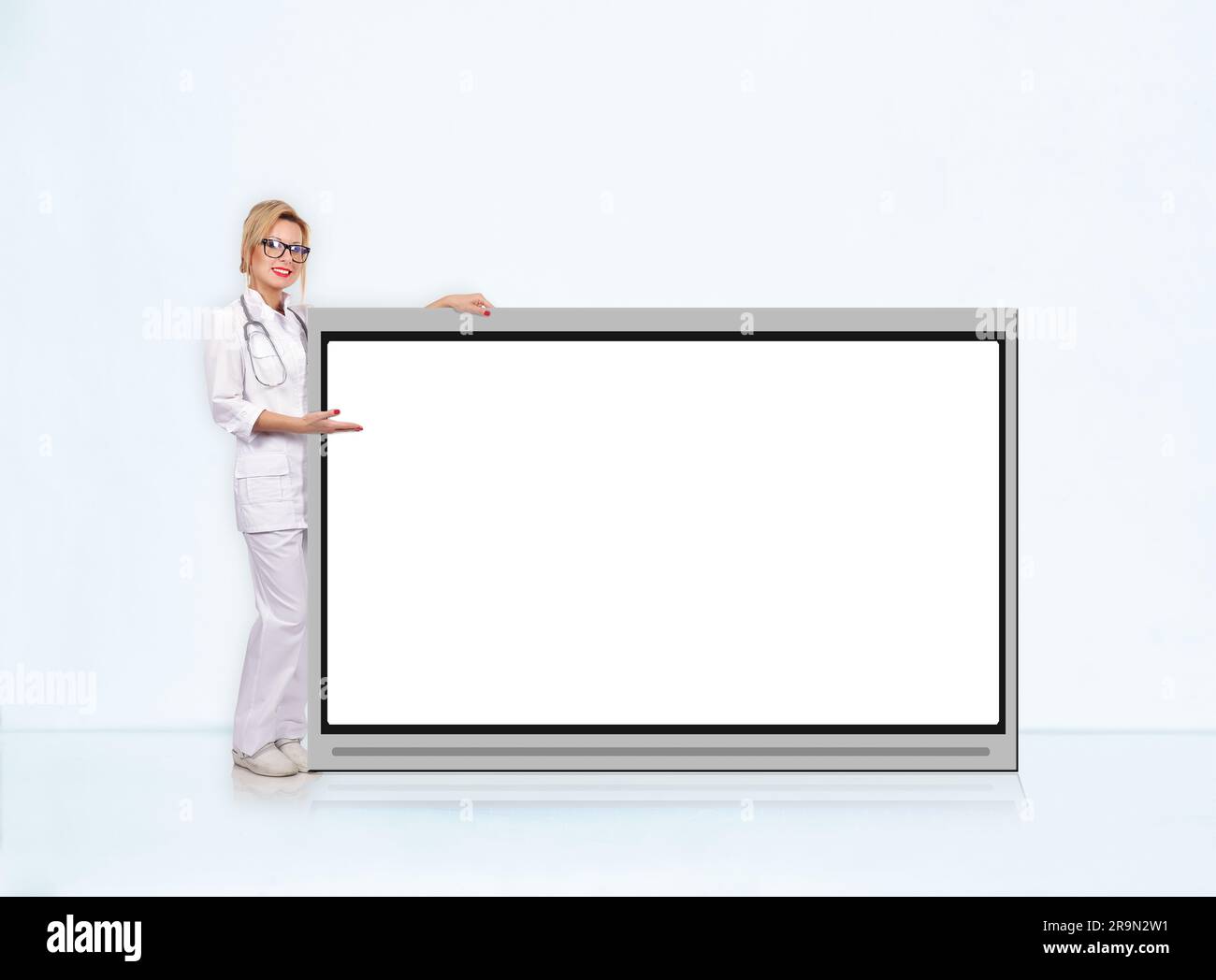 woman doctor with stethoscope showing blank tv screen Stock Photo - Alamy