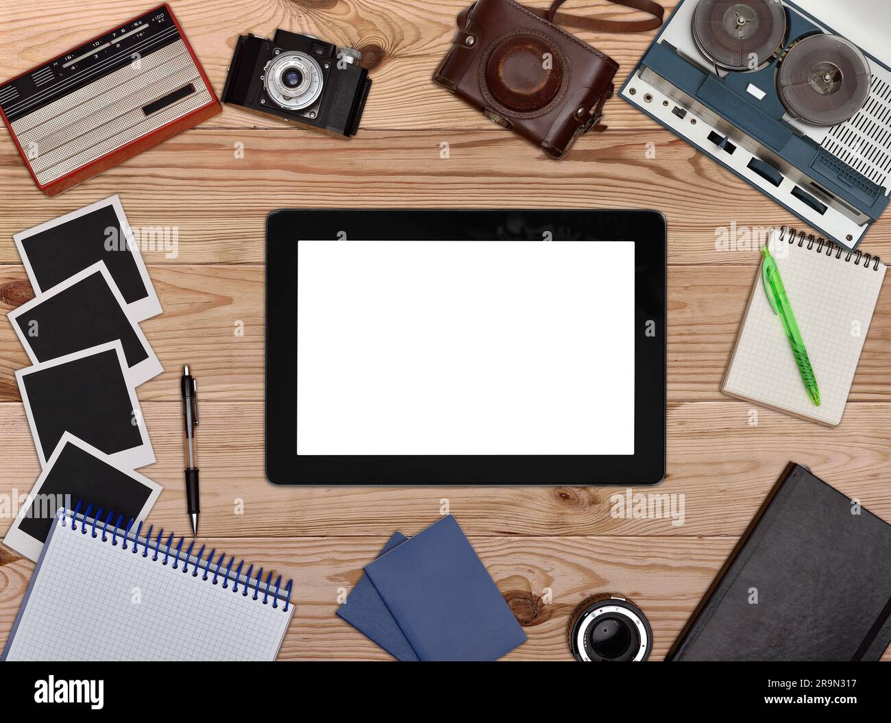 Retro reel tape recorder, vintage radio, retro camera on wooden table ...