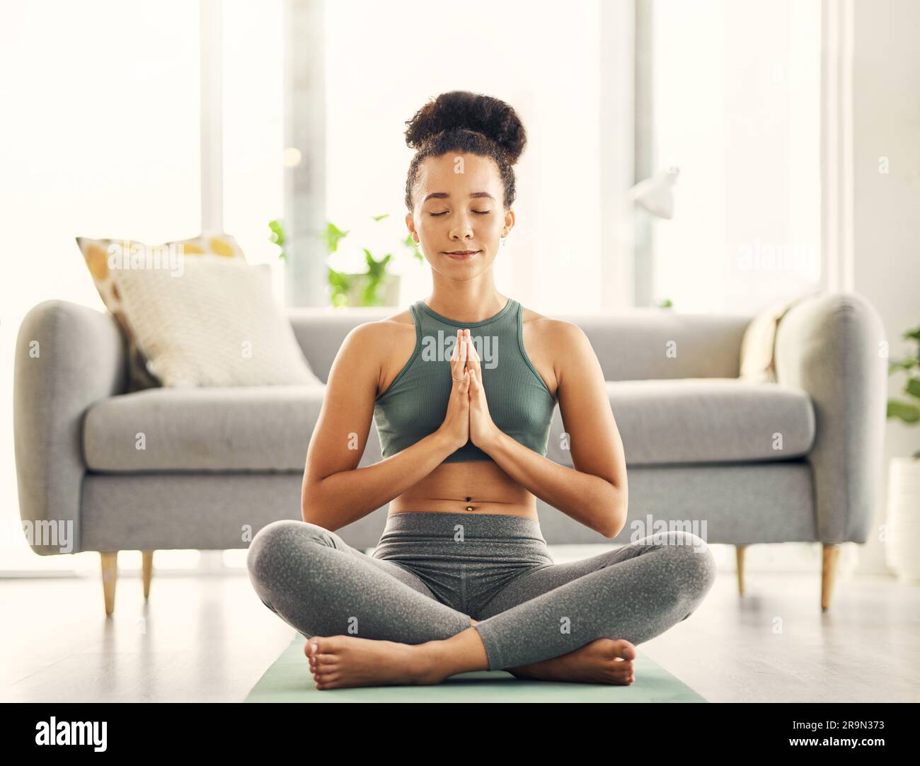 Meditation, praying hands and woman relax on living room floor for peace, wellness or mental ...