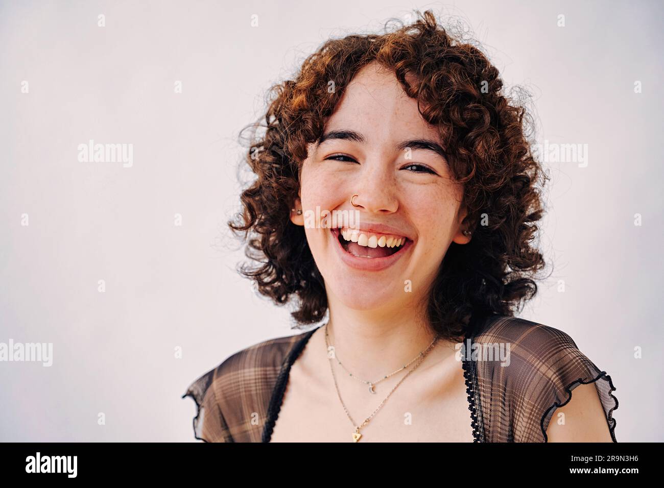 portrait of young adult woman with perfect toothy smile laughing ...