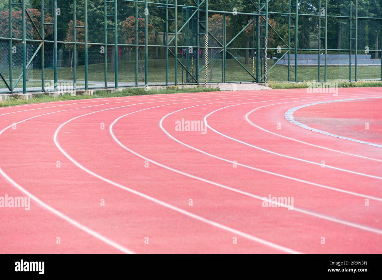 All-weather running track with red rubberized surface separated by ...