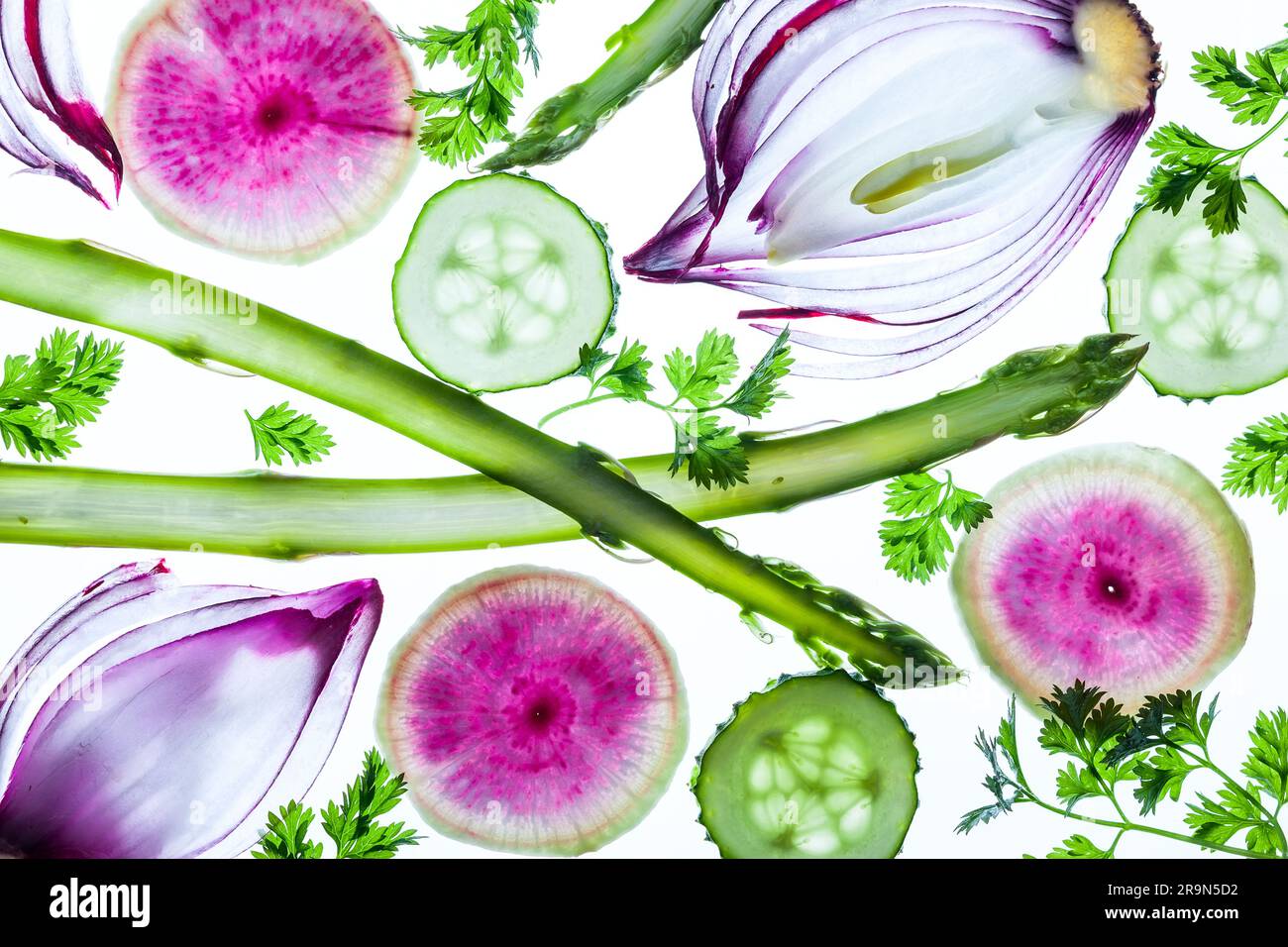 Thin slices of fresh vegetables on a white background Stock Photo - Alamy