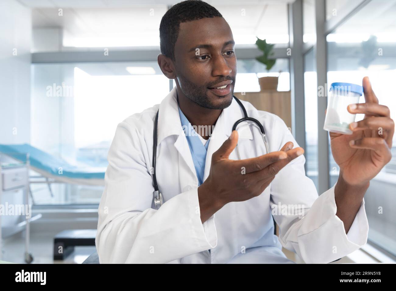 African american male doctor wearing lab coat and stethoscope, having ...