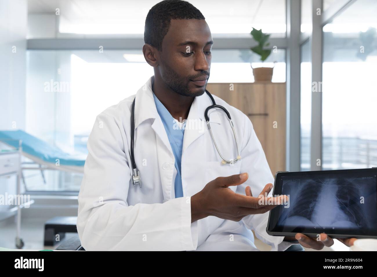 African american male doctor wearing lab coat and stethoscope, having ...