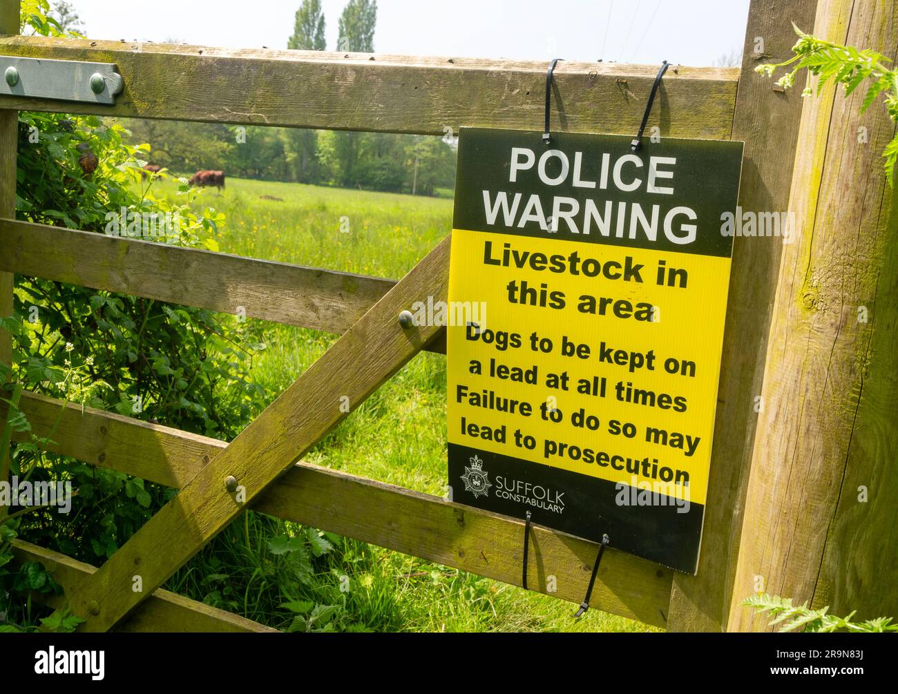 Police warning sign on gate about livestock in field, dogs to be kept ...