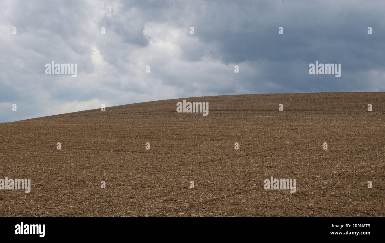 A scenic landscape showing an incline of dirt covered ground against a ...
