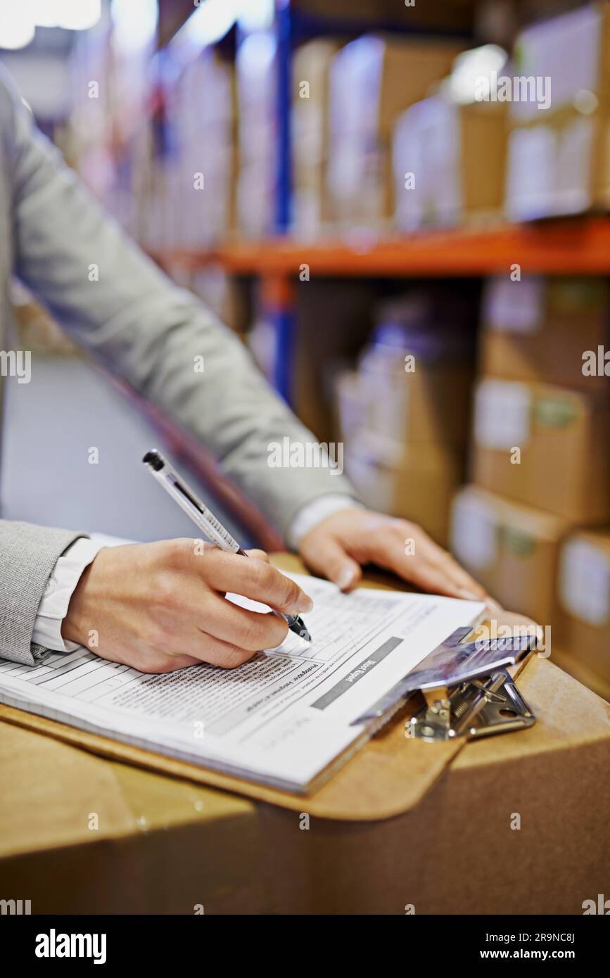 Hands, signature and clipboard with documents in warehouse, logistics ...
