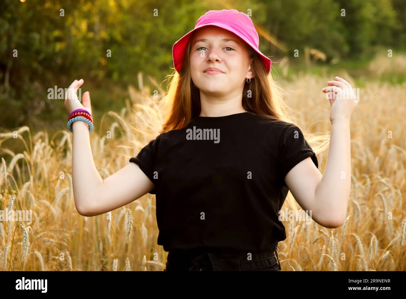 A cheerful teenage girl, aged 12 or 13, stands gracefully in a vibrant ...