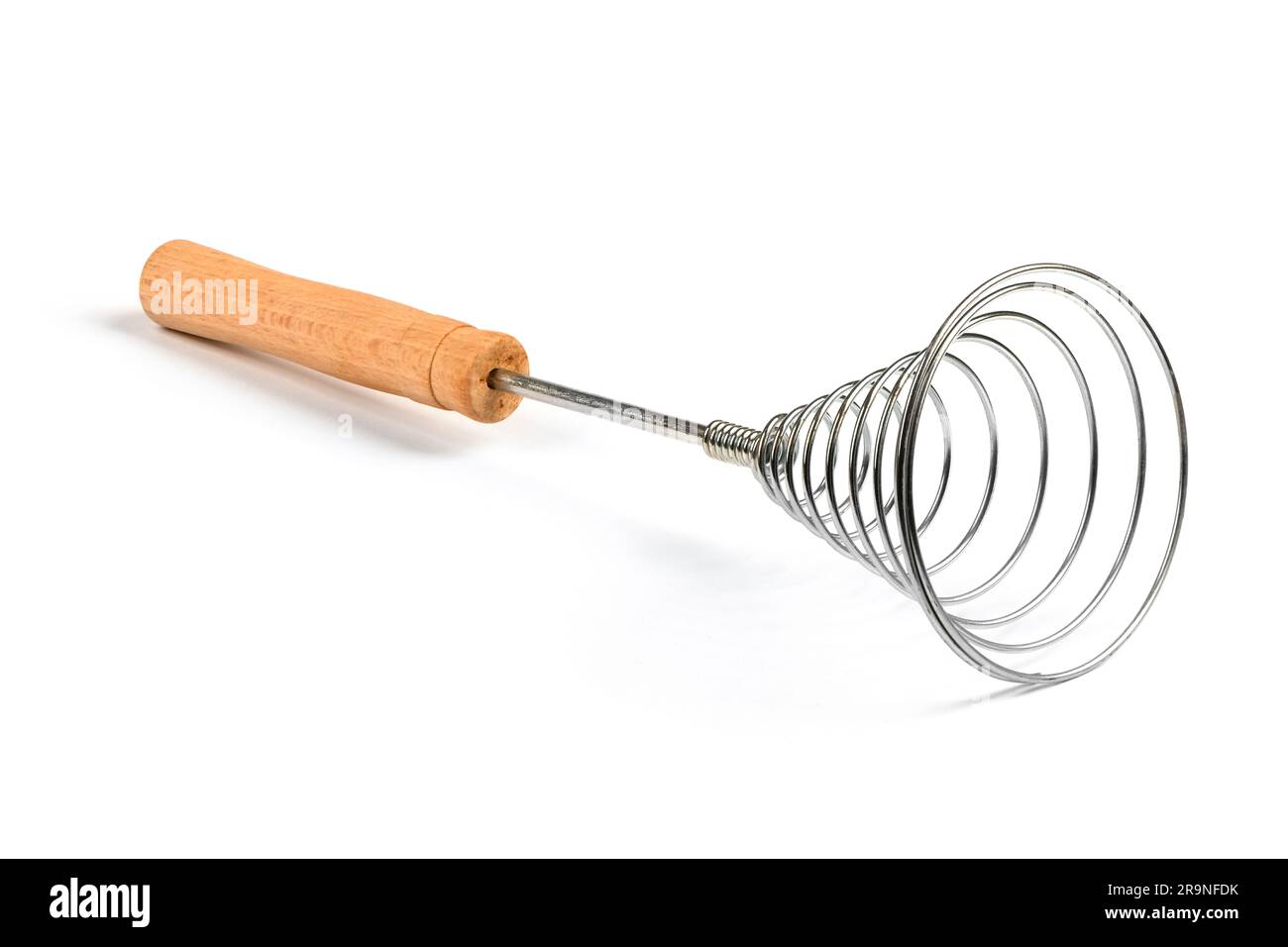 Close-up of old retro whisk kitchen tool on white background. Side view ...
