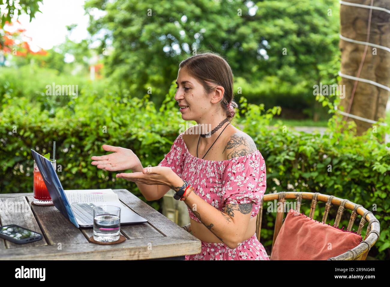 Cute videographer and vlogger taking a video with laptop camera in ...