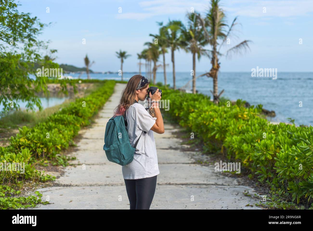 Cute photographer and travel blogger taking a photo with camera in ...
