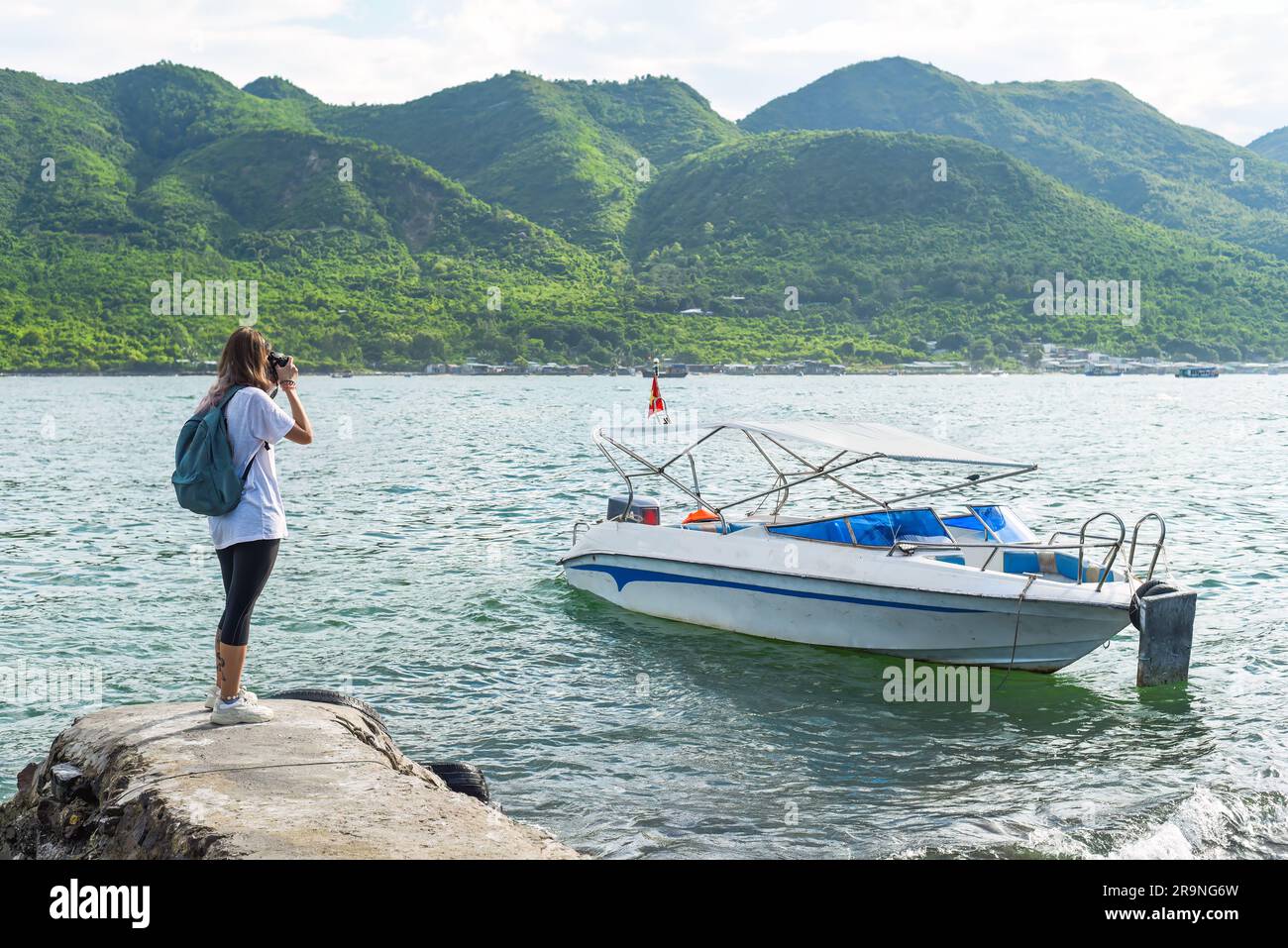 Cute photographer and travel blogger taking a photo with camera in ...