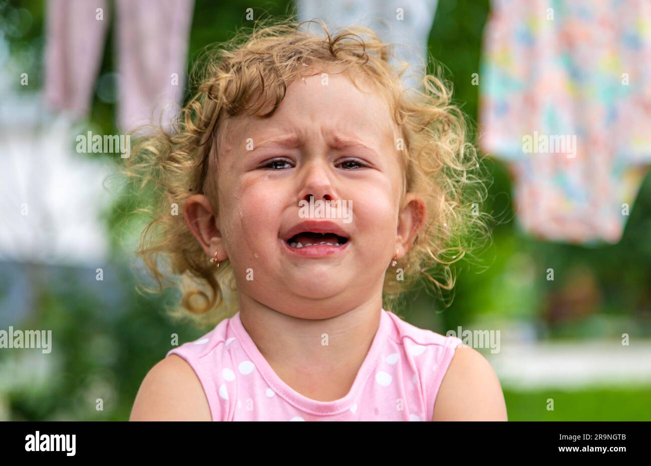 Child girl crying in the park. Selective focus. Kid Stock Photo - Alamy