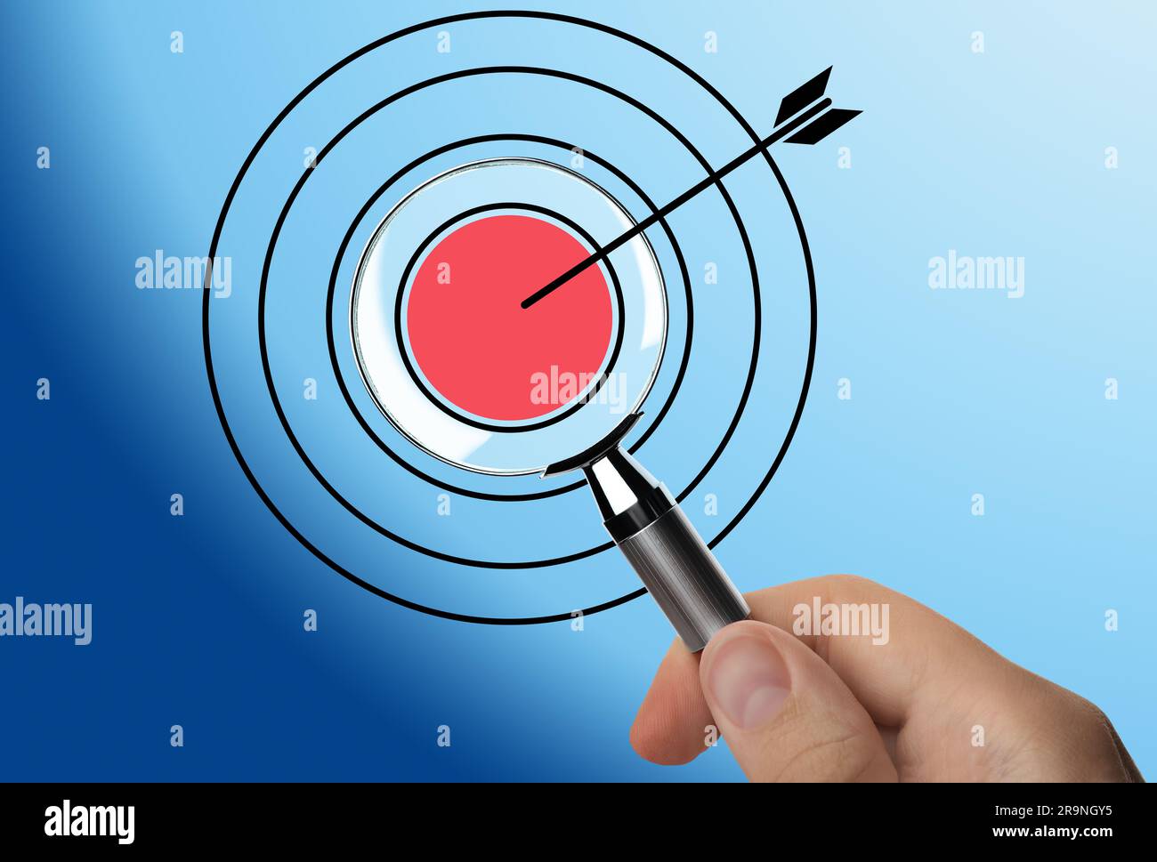 Woman holding magnifying glass on light blue gradient background ...