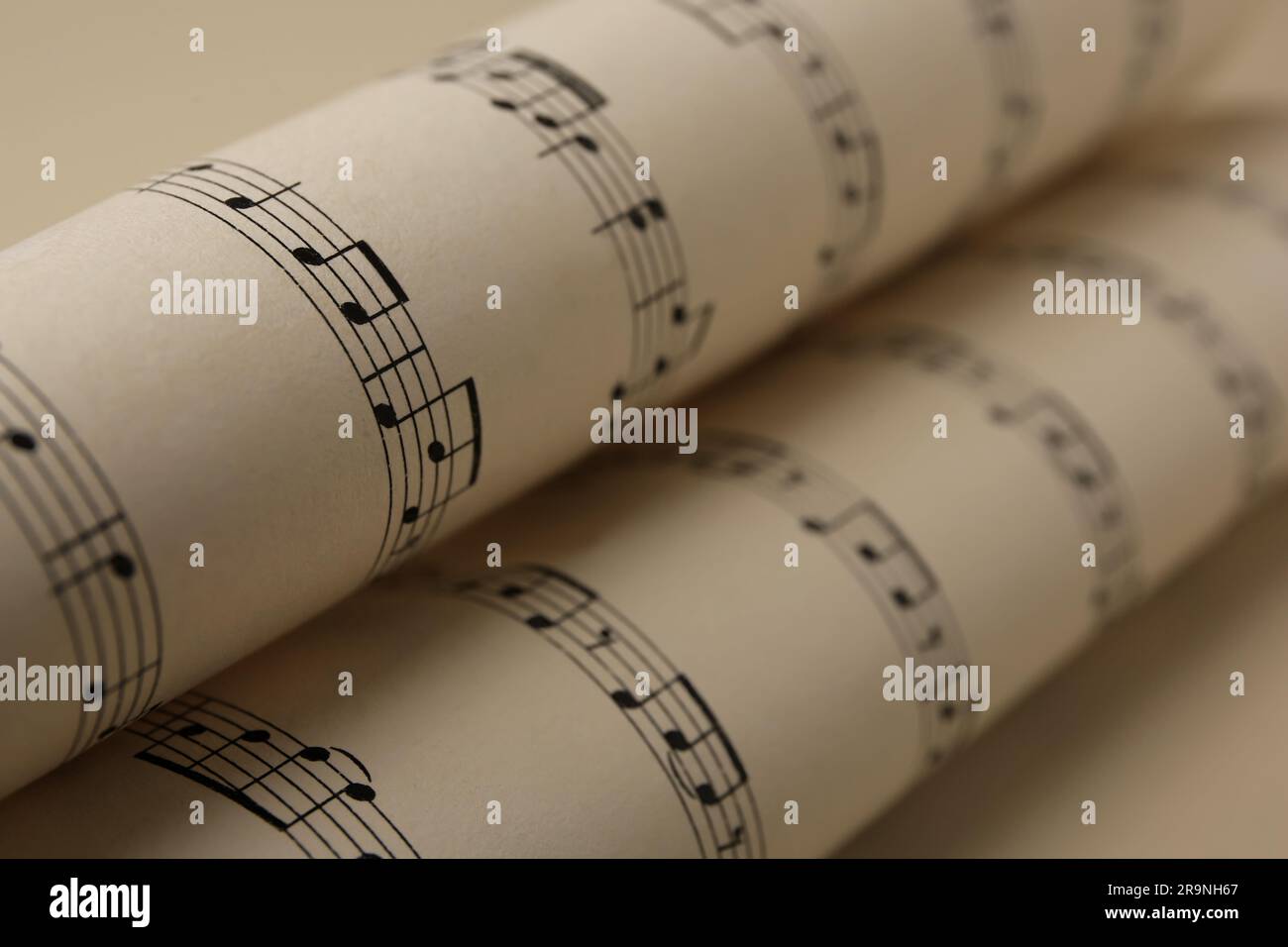 Rolled sheets with music notes on white background, closeup Stock Photo ...