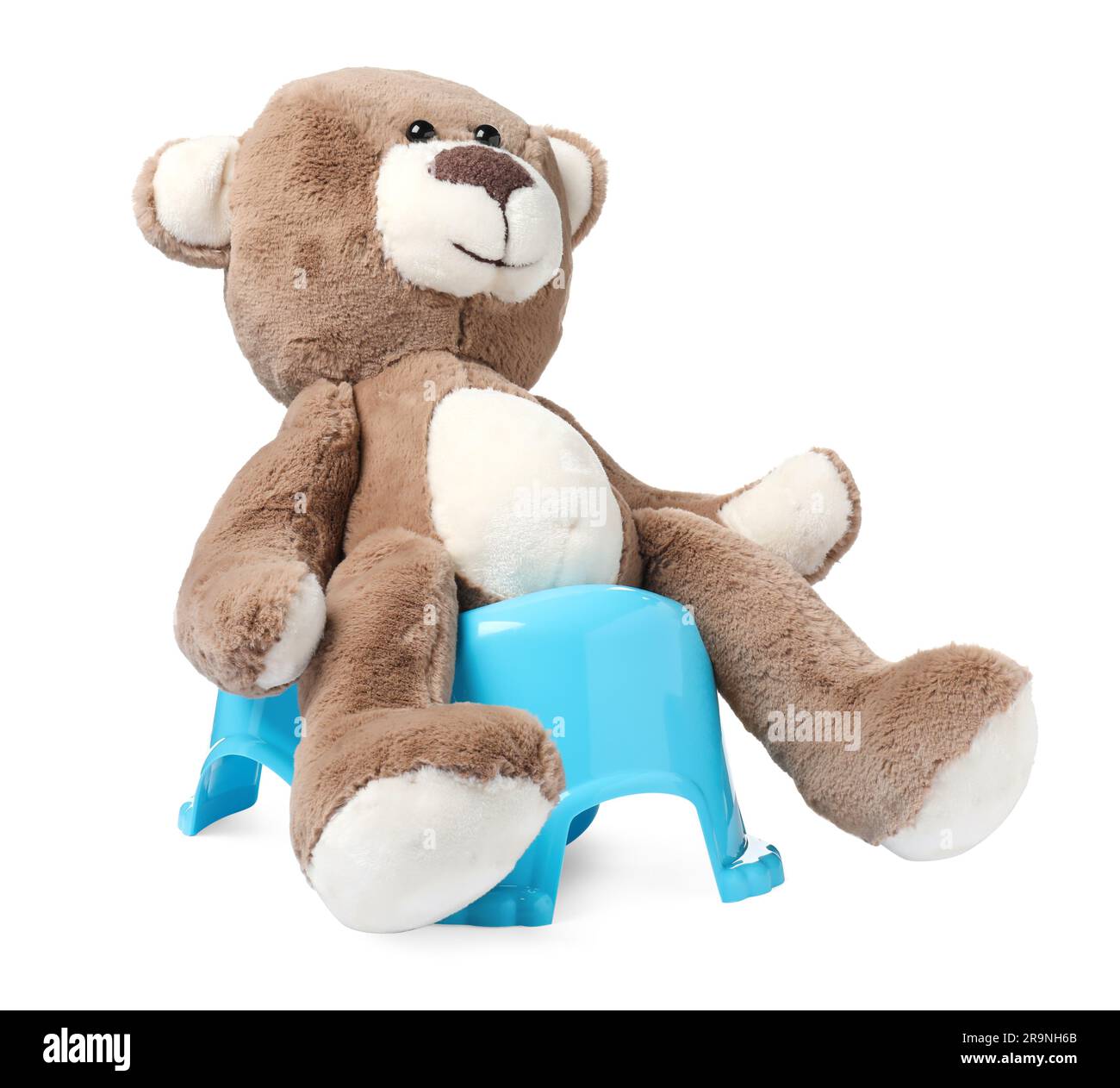 Teddy bear on light blue baby potty isolated on white. Toilet training ...
