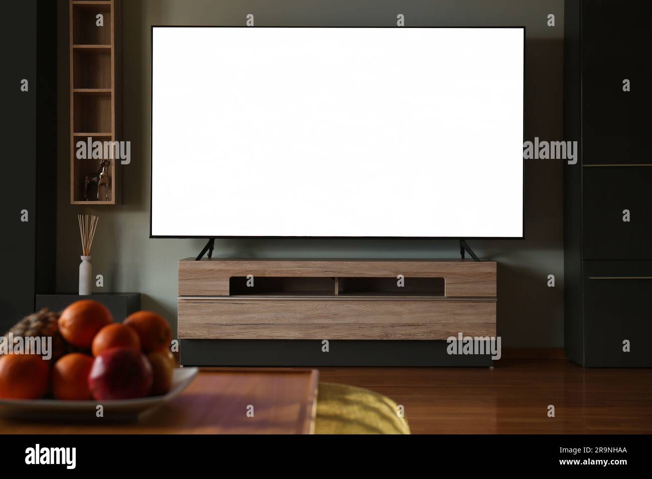 Modern TV set on table in room. Interior design Stock Photo - Alamy