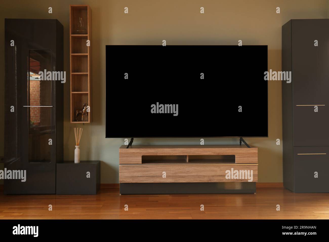 Modern TV set on table in room. Interior design Stock Photo - Alamy