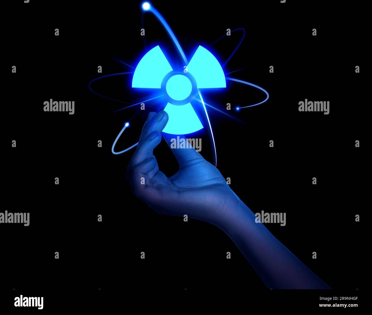 Woman holding glowing atom symbol with radiation warning sign on black ...