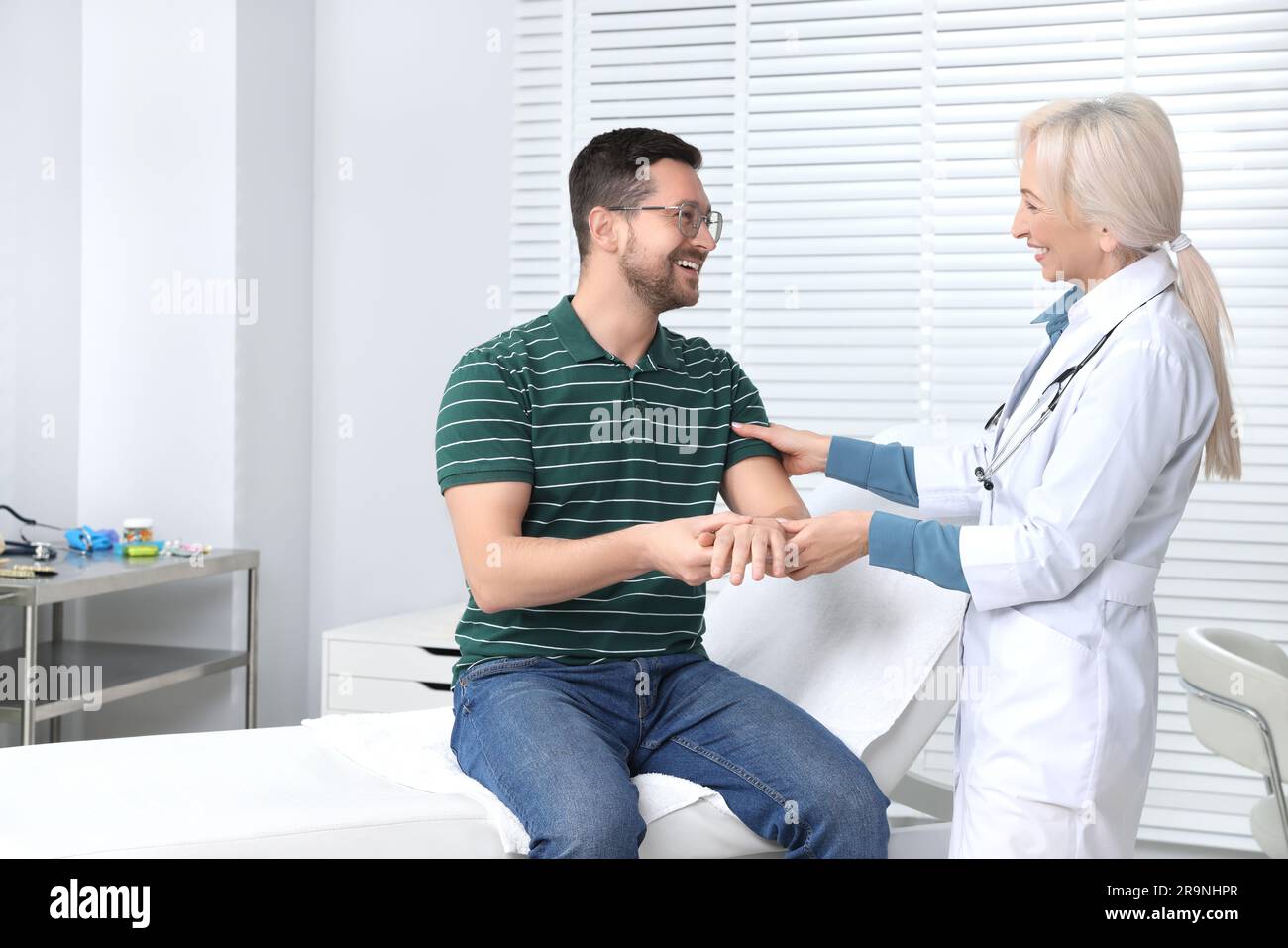 Male caucasian doctor checking patients pulse hi-res stock photography ...