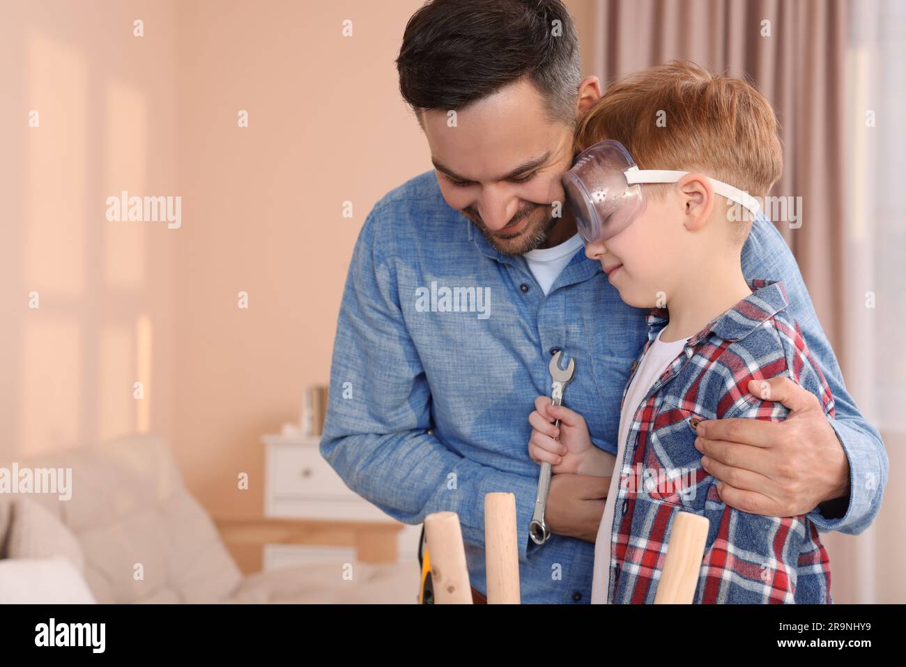 Father and son repairing stool at home, space for text Stock Photo - Alamy