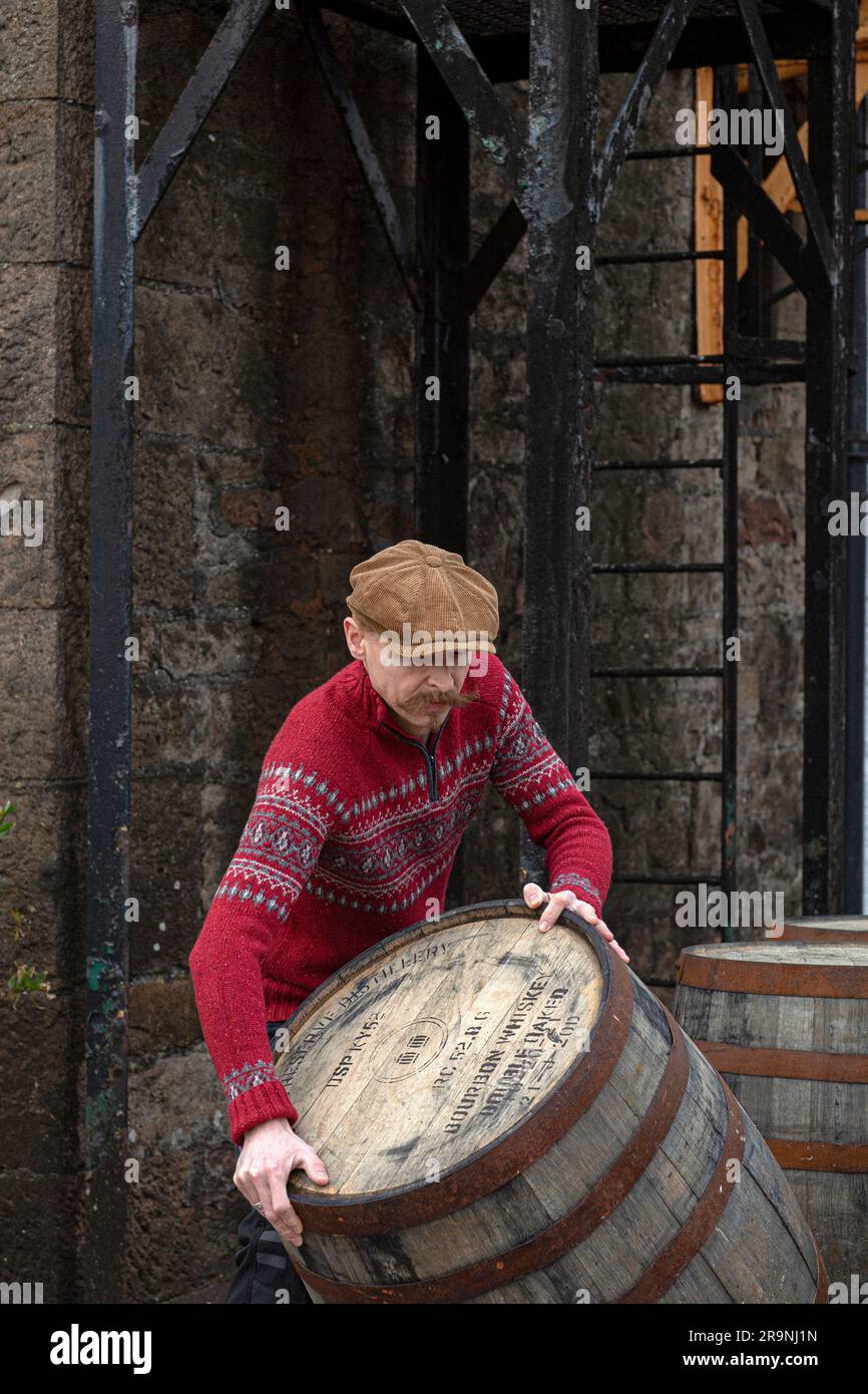 Worker rolling whisky cask in whisky distillery , Scotland Stock Photo ...