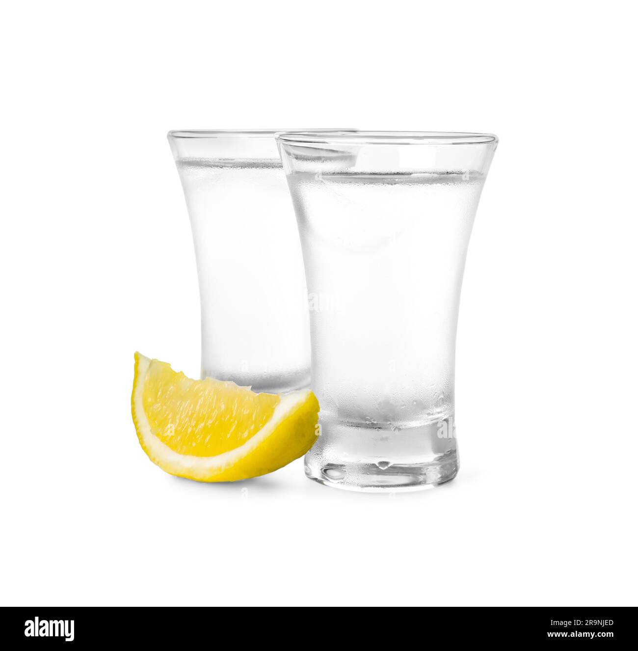 Shot glasses of vodka with lemon slice on white background Stock Photo ...