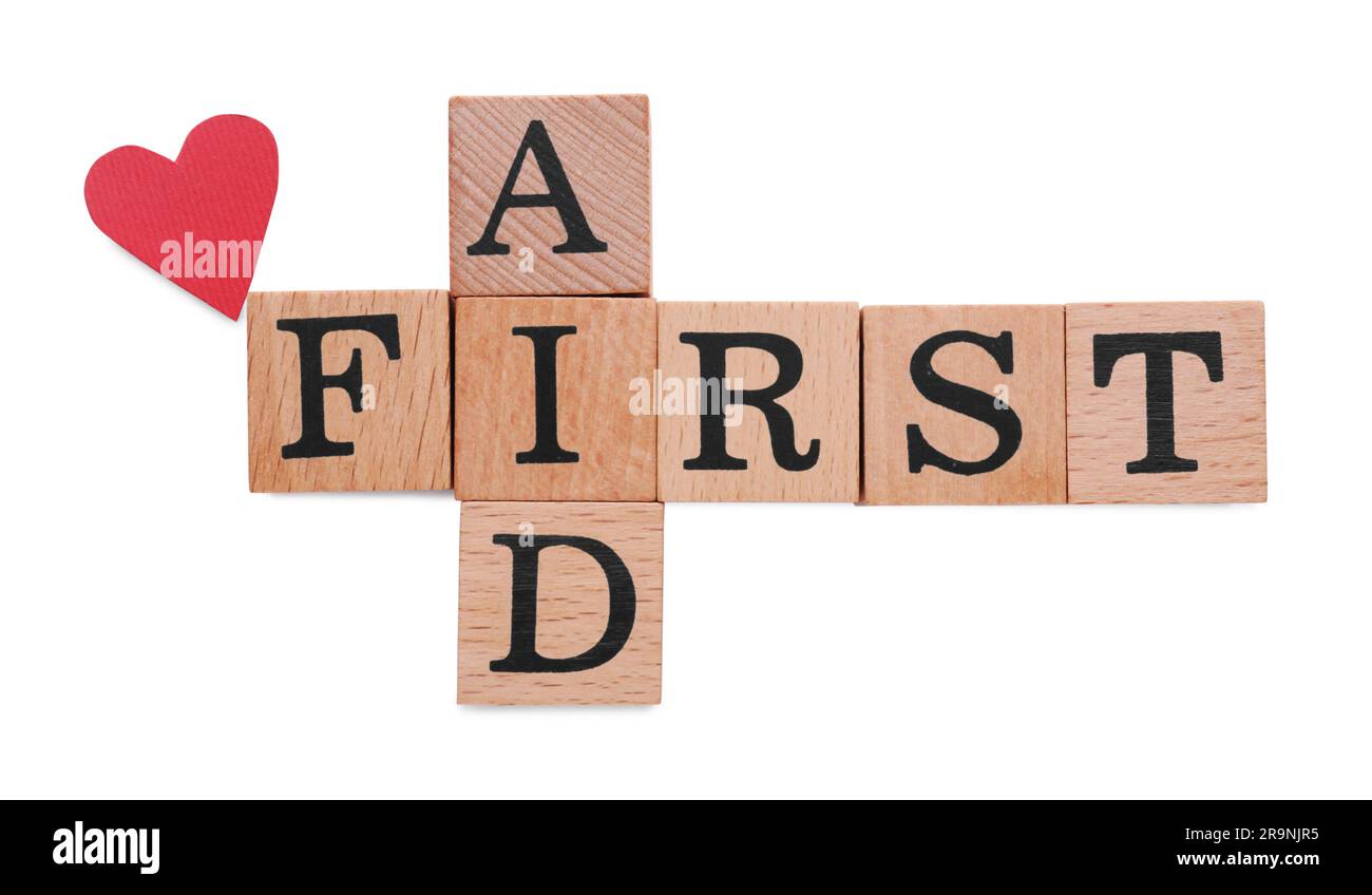 Words First Aid made of wooden cubes and cardboard heart isolated on ...
