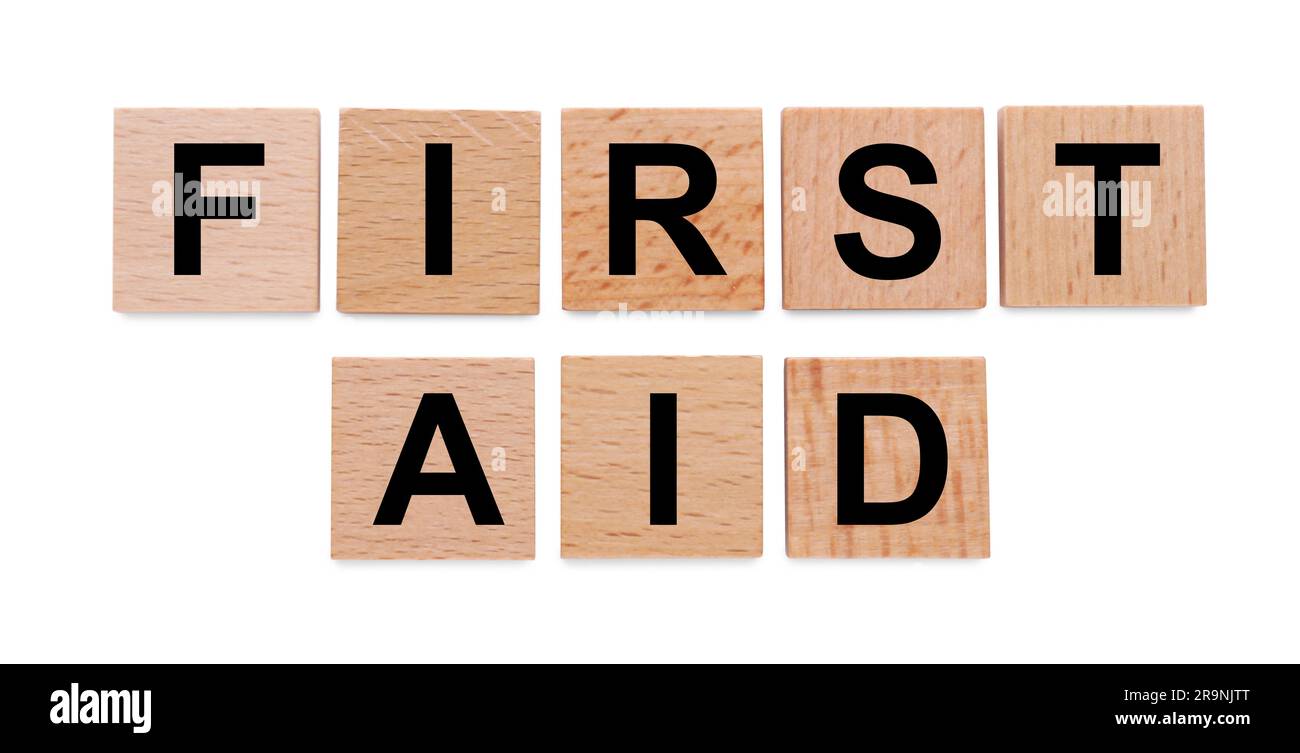 Words First Aid made of wooden cubes isolated on white, top view Stock ...