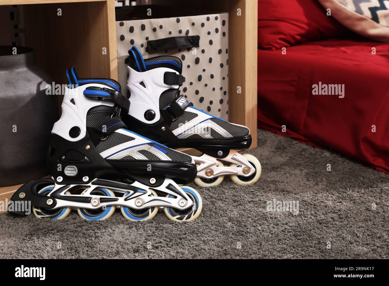 Stylish roller skates on gray rug in teenager's room Stock Photo - Alamy