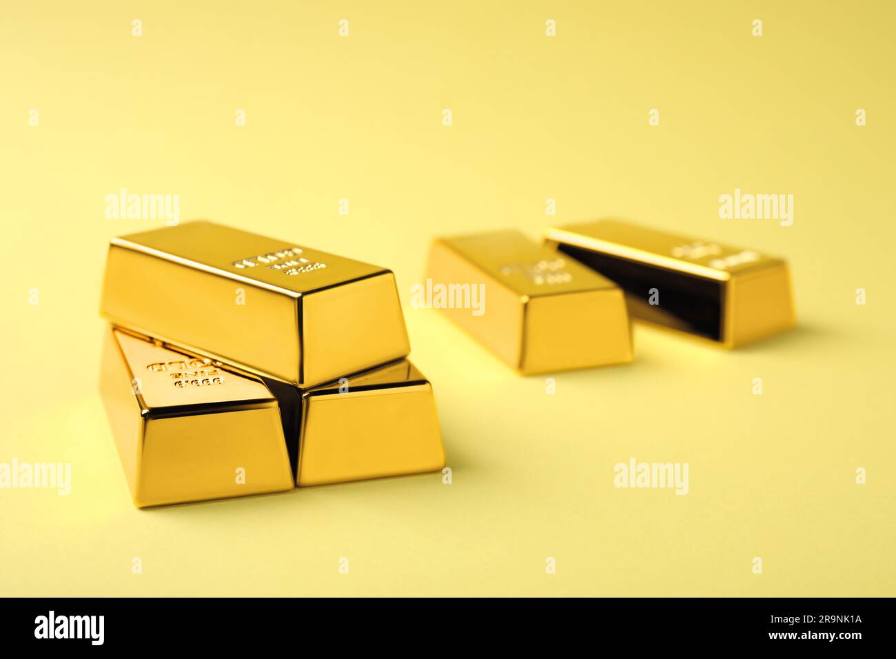 Shiny gold bars on yellow background. Space for text Stock Photo - Alamy