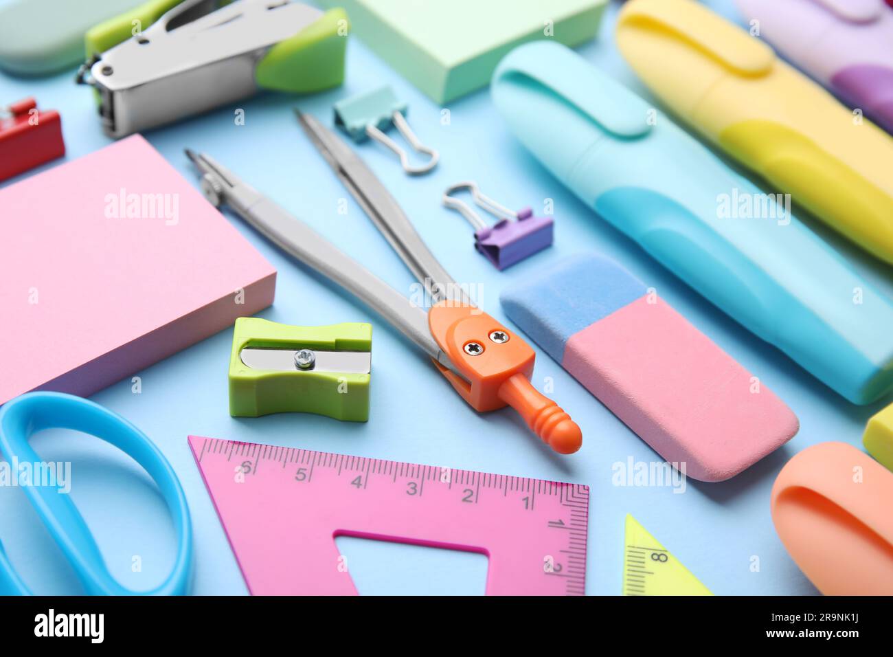 Many different school stationery on light blue background, closeup ...