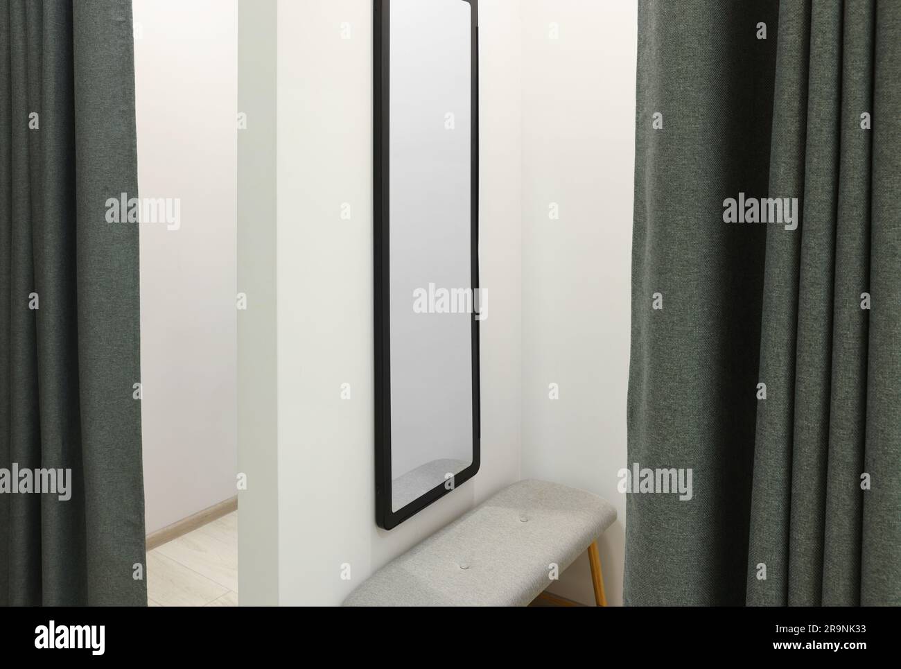 Dressing room with mirror in fashion store. Stylish design Stock Photo ...