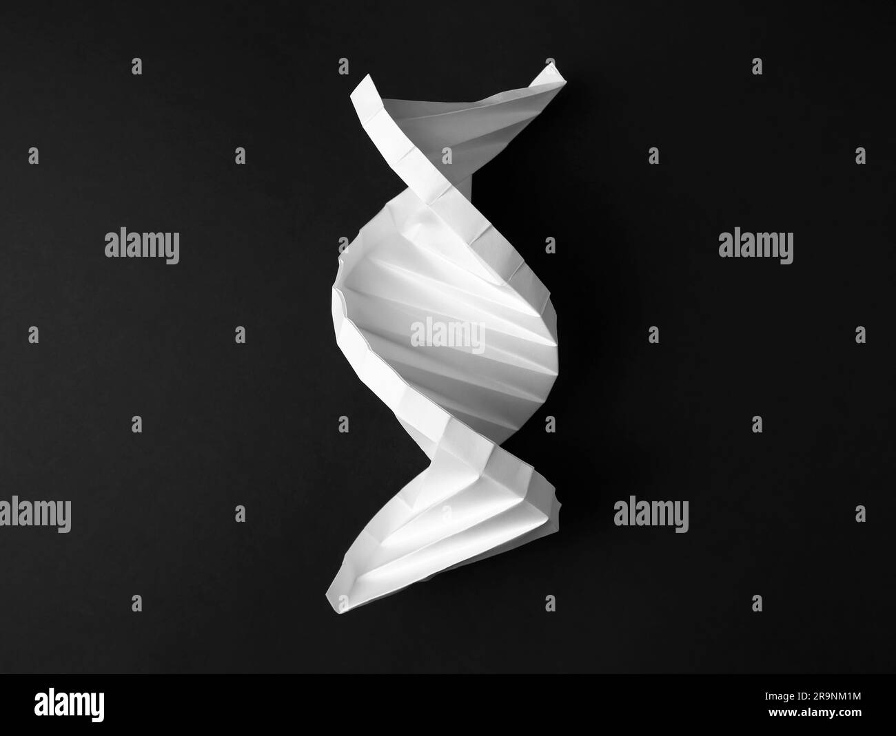 Paper model of DNA molecular chain on black background, top view Stock ...