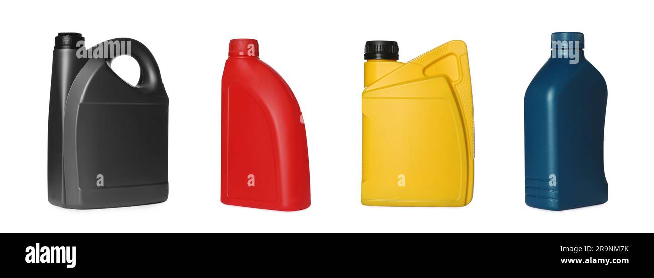 Colorful containers with different motor oil on white background ...