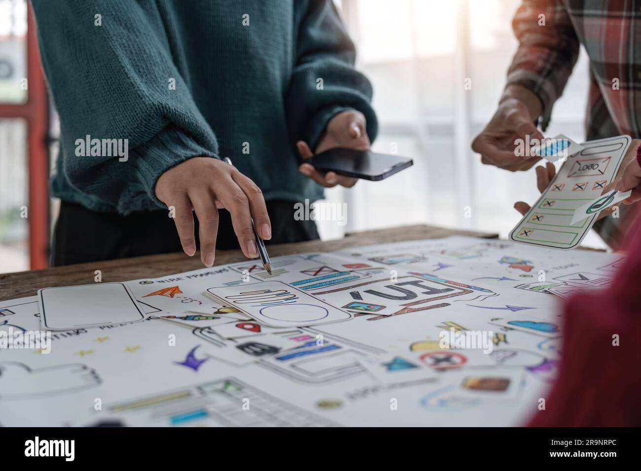 Ux Developer And Ui Designer Brainstorming About Mobile App Interface Wireframe Design At Modern