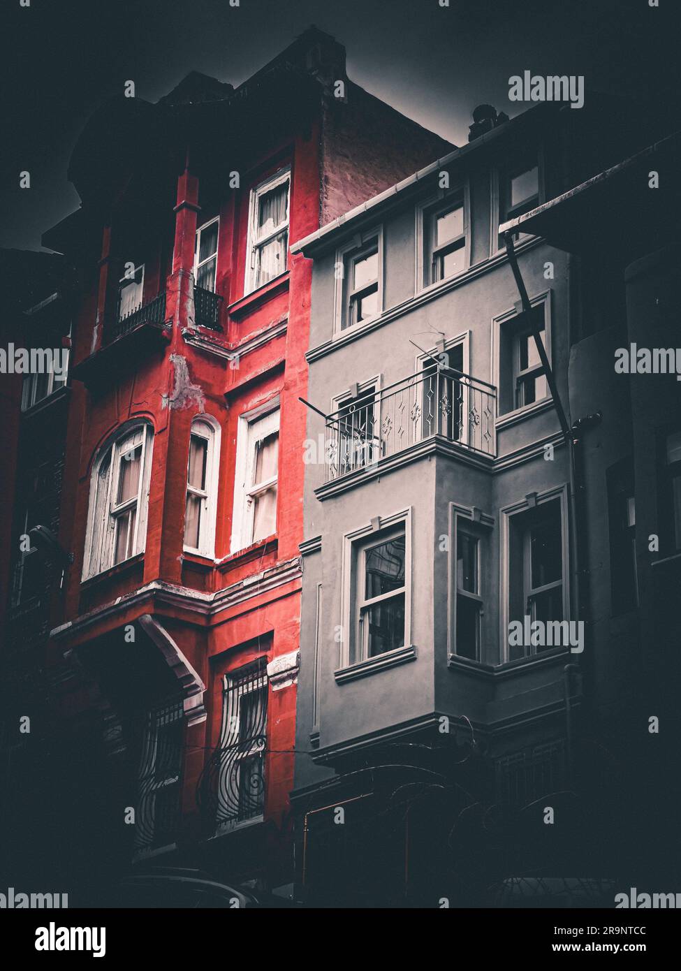 A low-angle shot of a red and gray building side by side - contrast of ...
