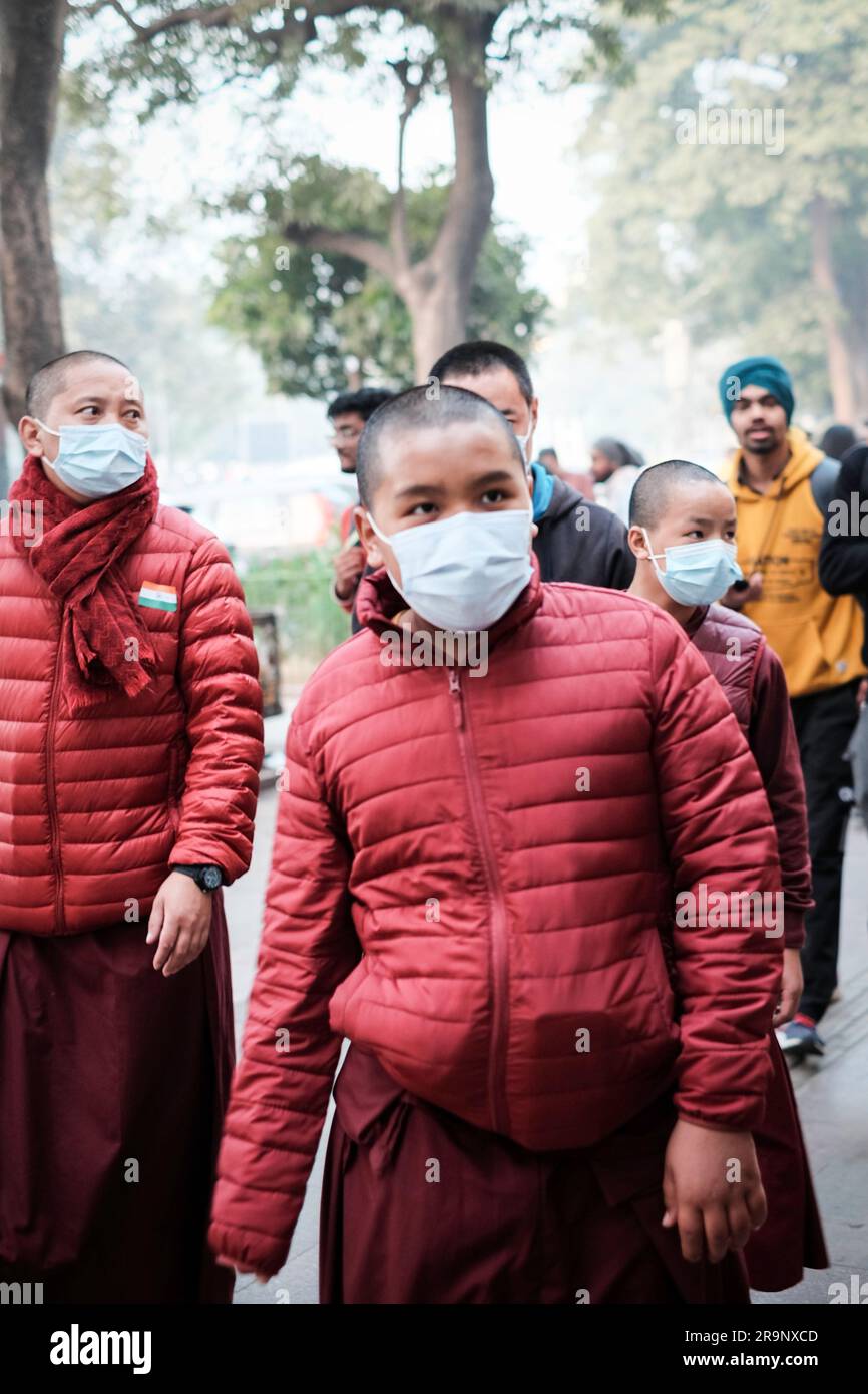 A group of people wearing face masks walking along a busy street, New ...