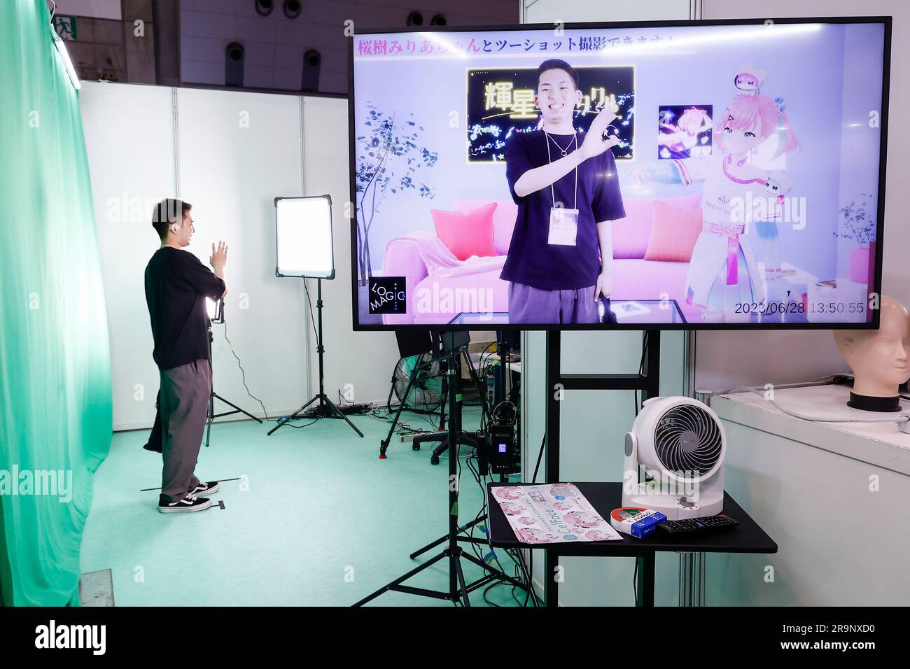 Tokyo, Japan. 28th June, 2023. A screen shows an exhibitor interacting ...