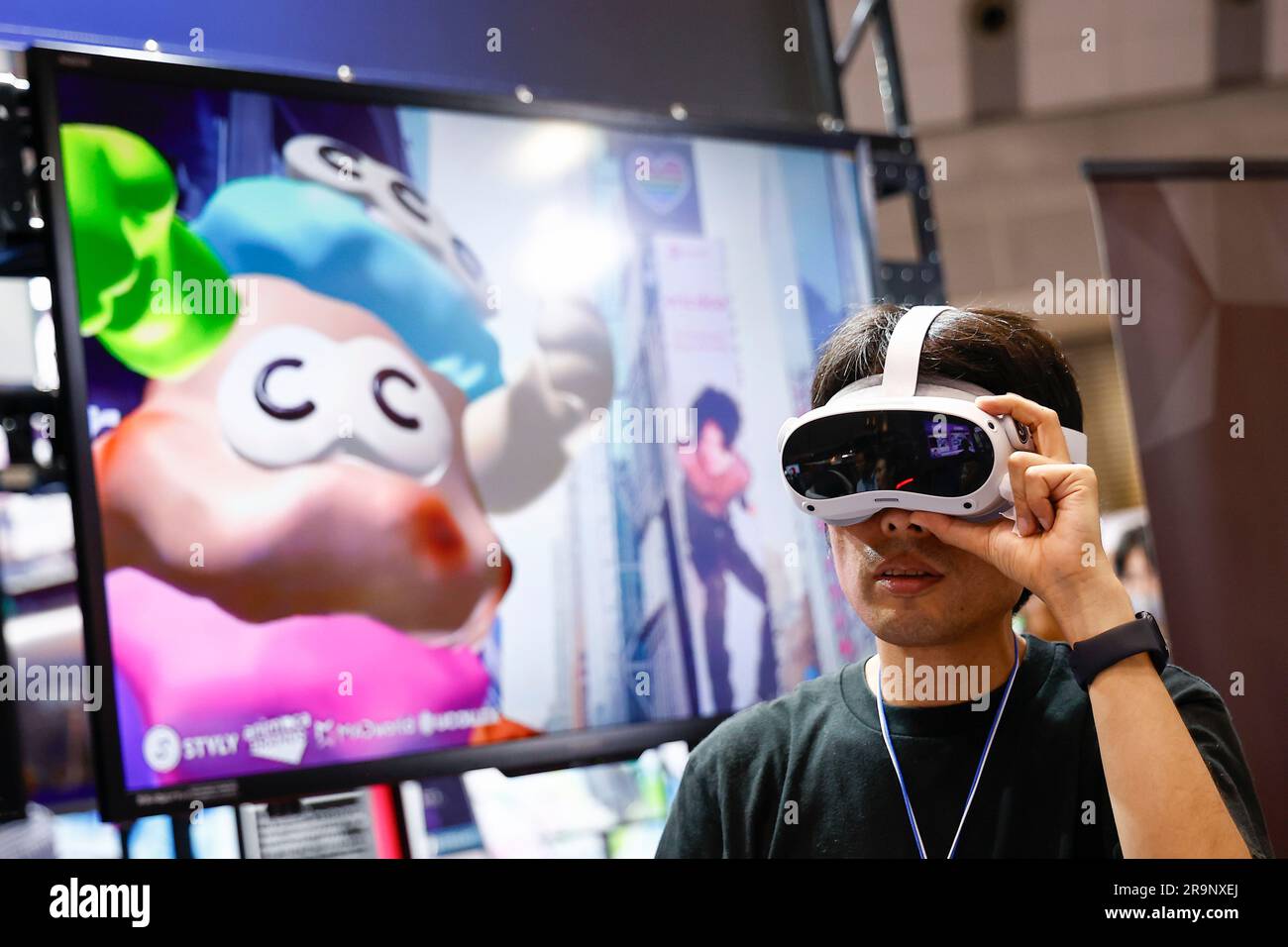 Tokyo, Japan. 28th June, 2023. An exhibitor tests Virtual Reality (VR ...