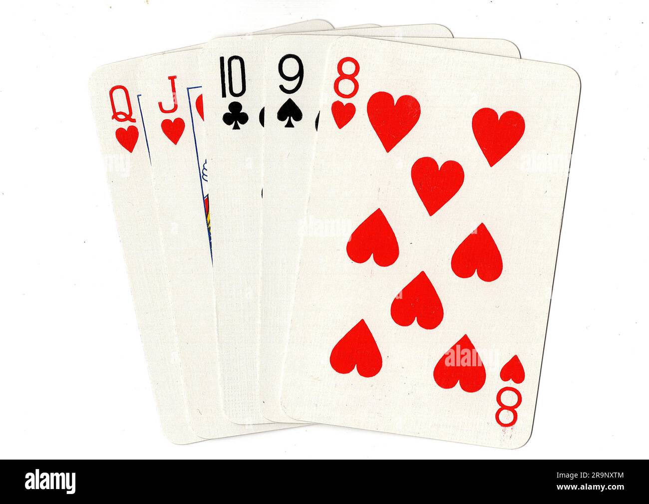 Playing cards in a poke hand showing a straight on a white background ...