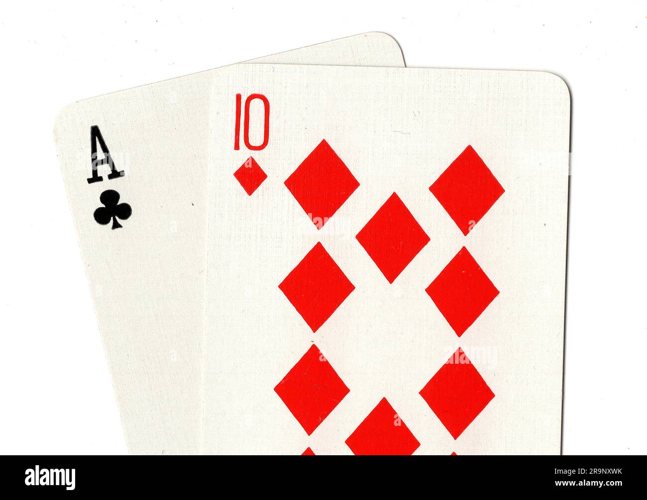Vintage playing cards showing an ace of clubs and ten of diamonds on a ...